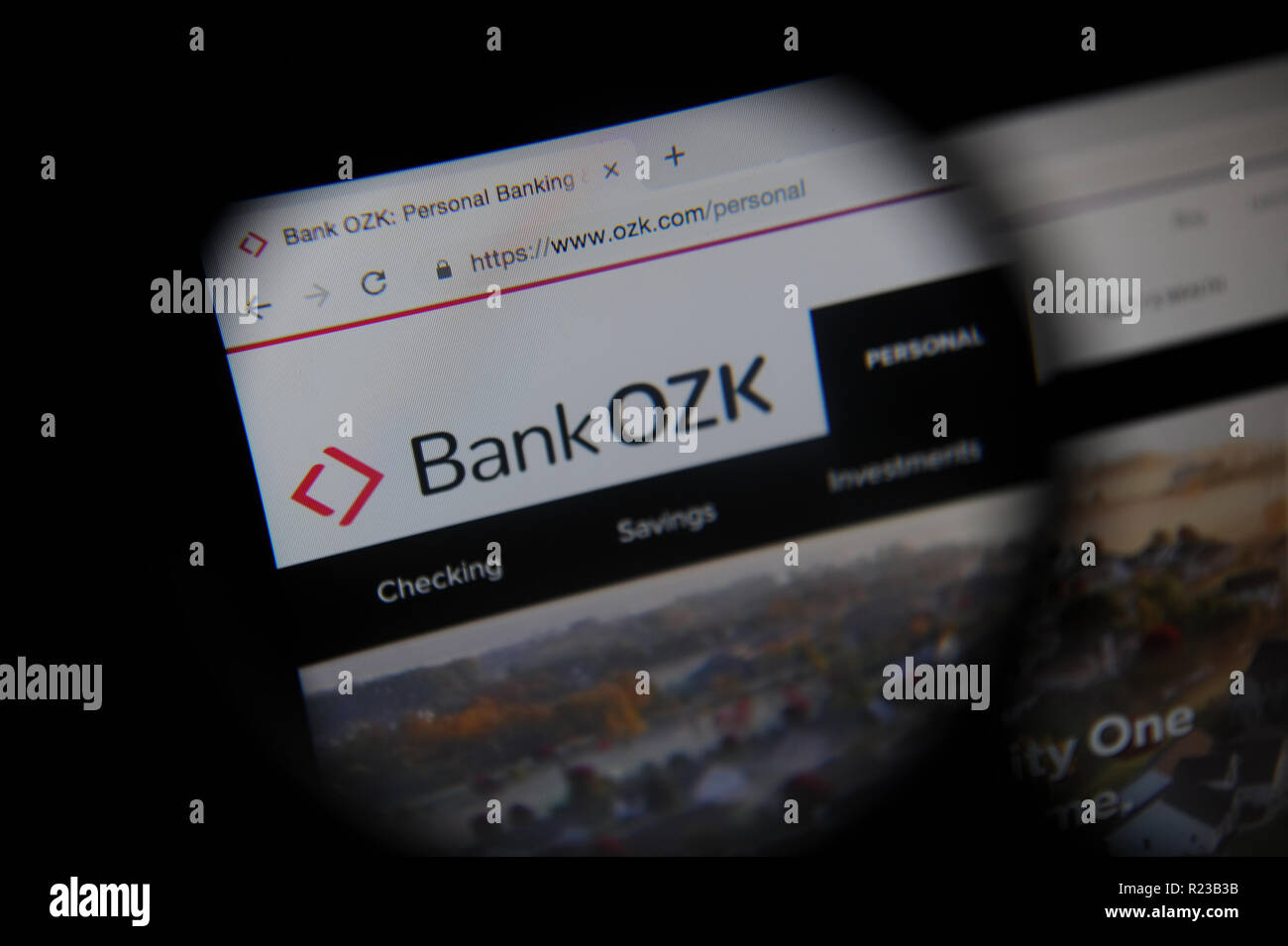 Bank OZK (formerly Bank of the Ozarks) seen through a magnifying glass ...