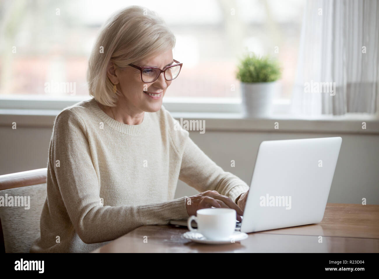 Old woman reading glasses computer hi-res stock photography and images ...
