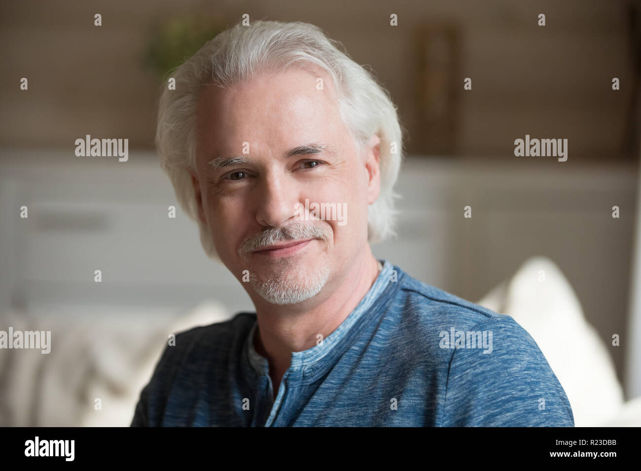 Close up portrait of smiling aged man with moustache looking at camera ...