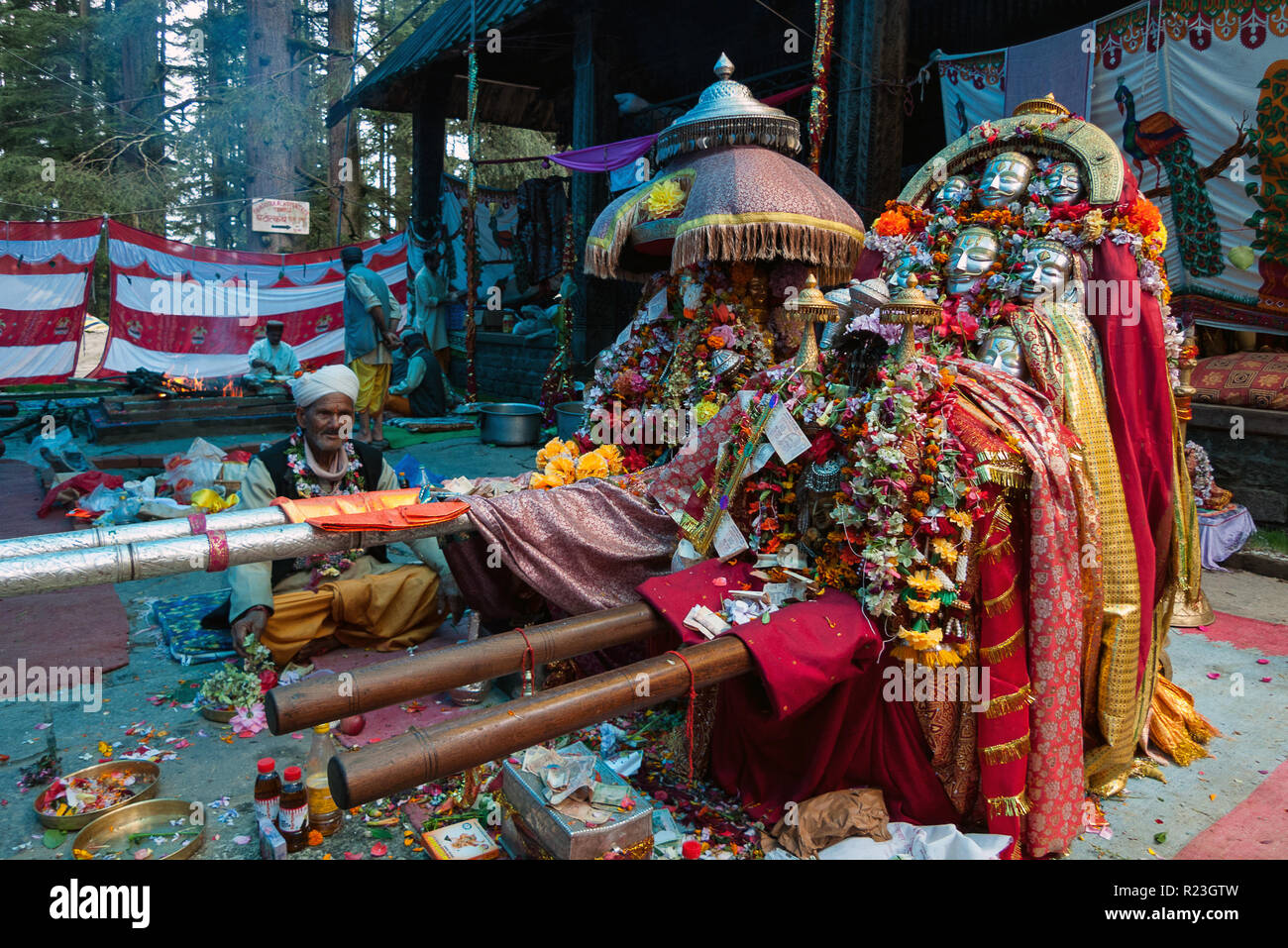 India, Himachal Pradesh, Manali: a Hindu priest sits near the masks and ...