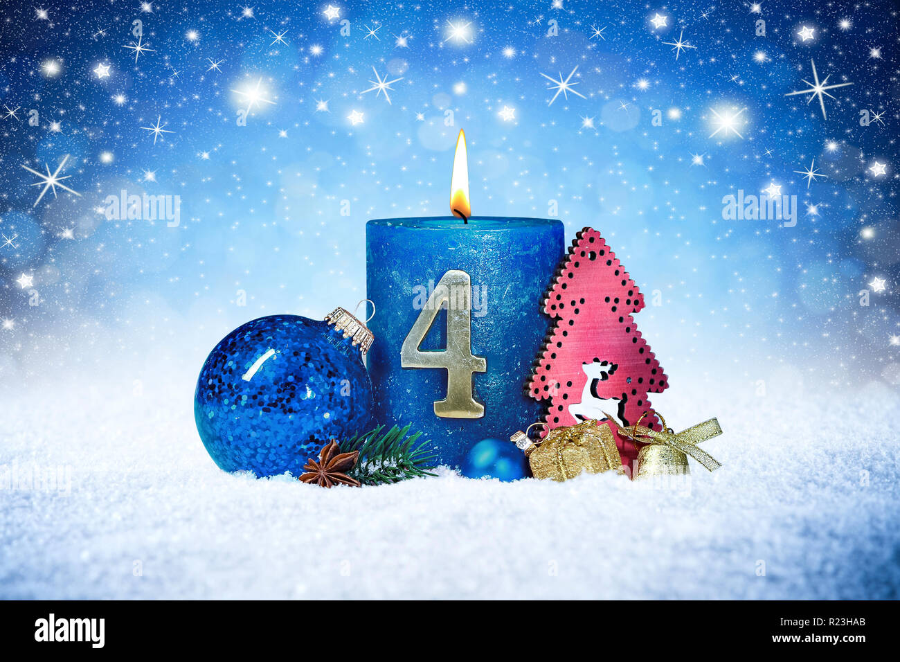 fourth sunday of advent blue candle with golden metal number red ...