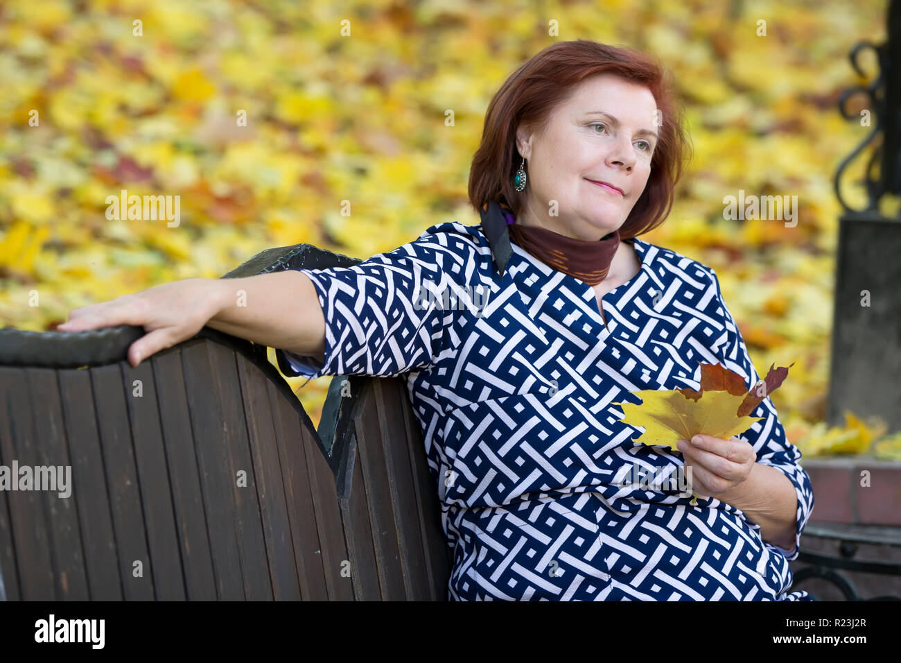 Elderly woman with autumn leaves.Autumn age Stock Photo - Alamy