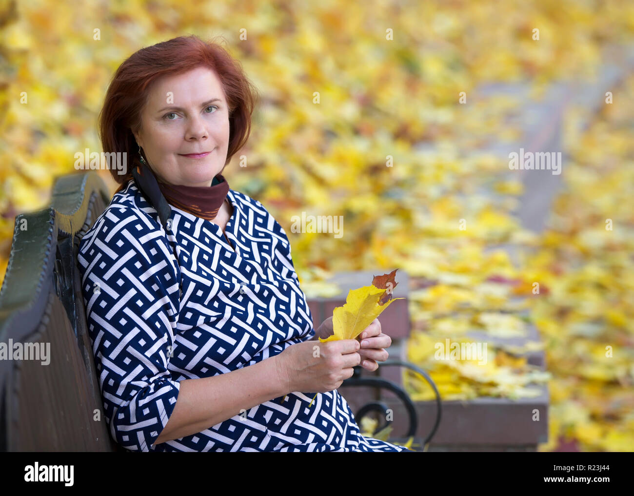 Elderly woman with autumn leaves.Autumn age Stock Photo - Alamy
