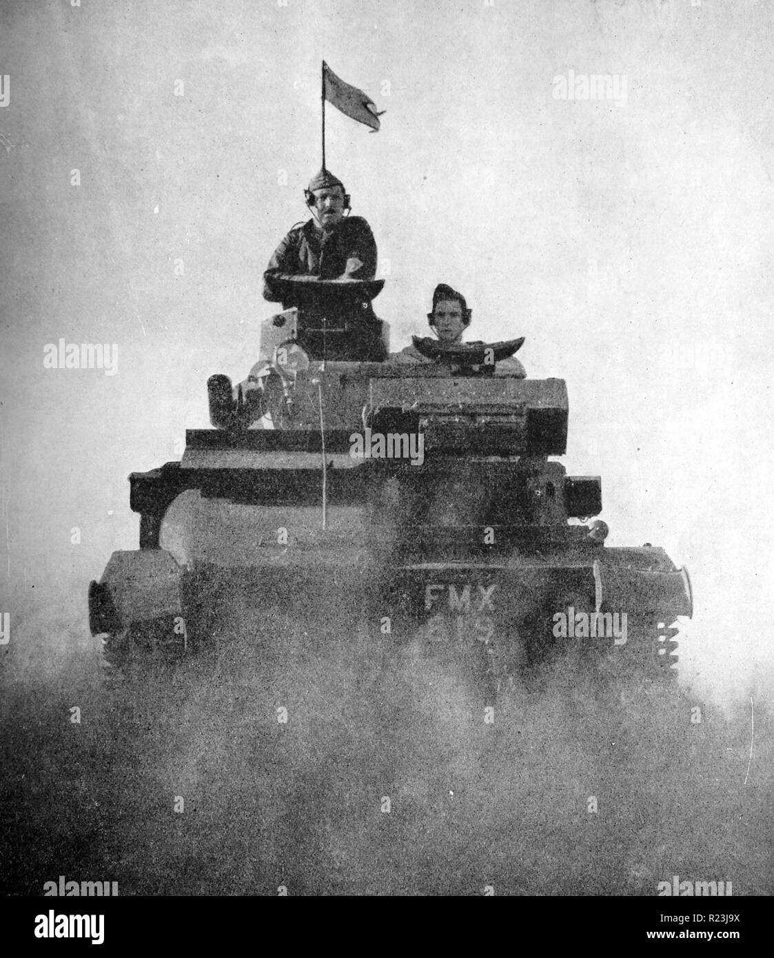 Photograph of a tank being used during World War Two. The flags borne ...