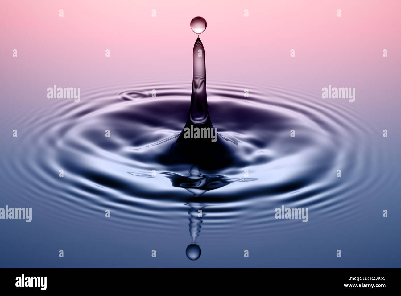 Colorful water splash. Falling drop of water Stock Photo - Alamy