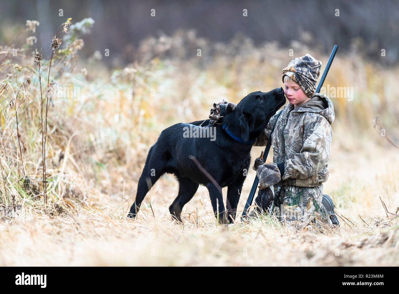 A young duck hunter with his dog Stock Photo - Alamy