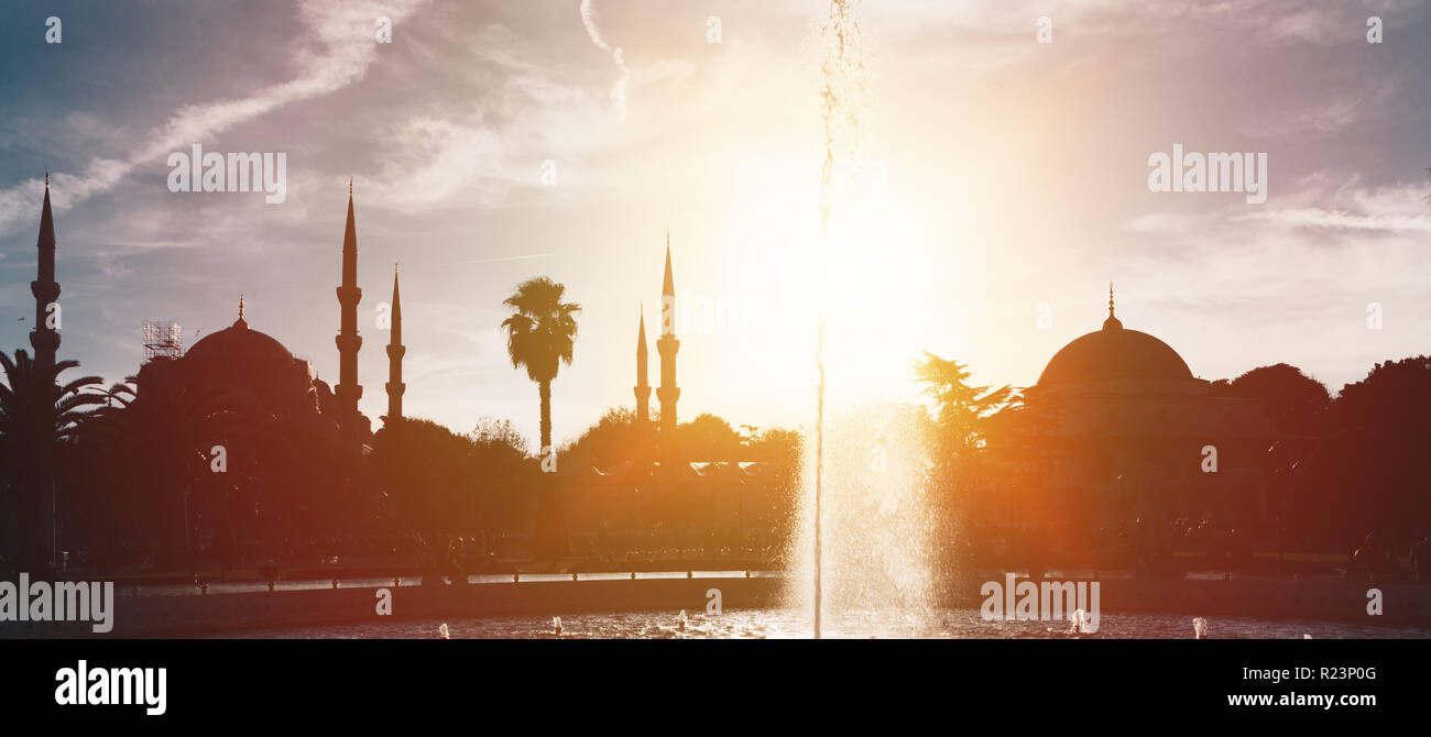 blue mosque silhouette at sunset with rays light warm look and feel ...