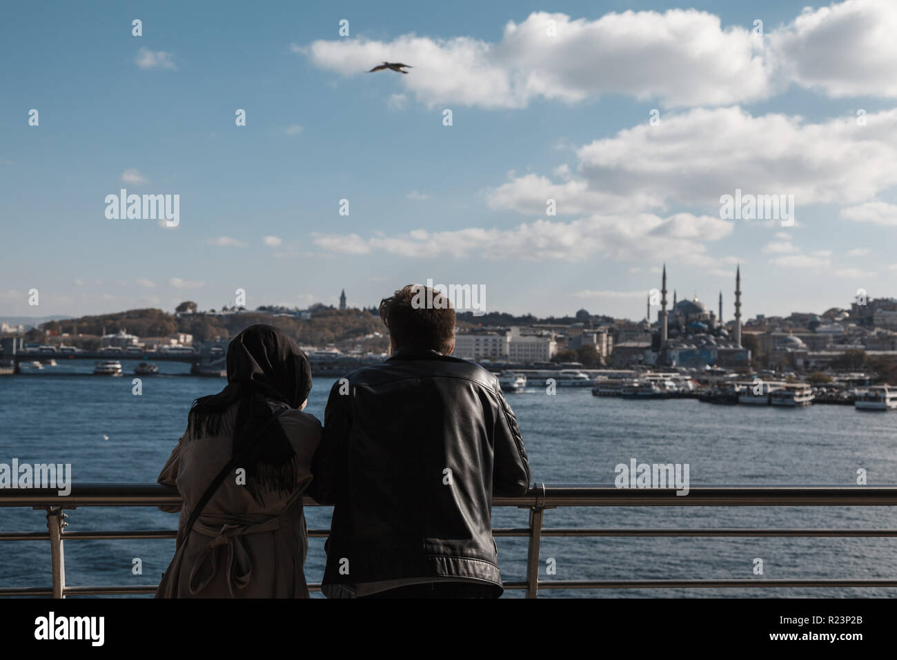 muslim couple hand in hand looking the amazing view of istanbul from ...