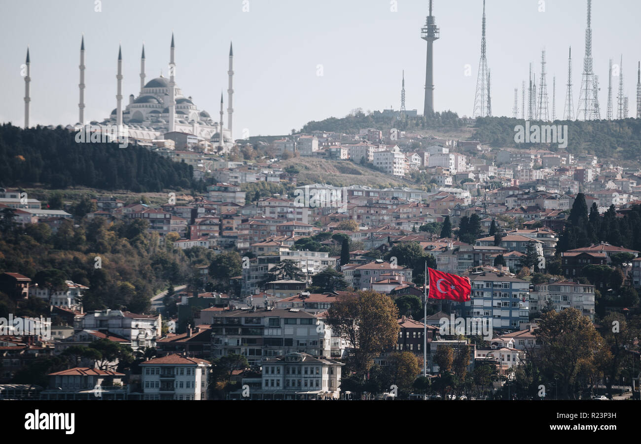 view of shoreline of Istanbul from the boat with towers, flag and ...