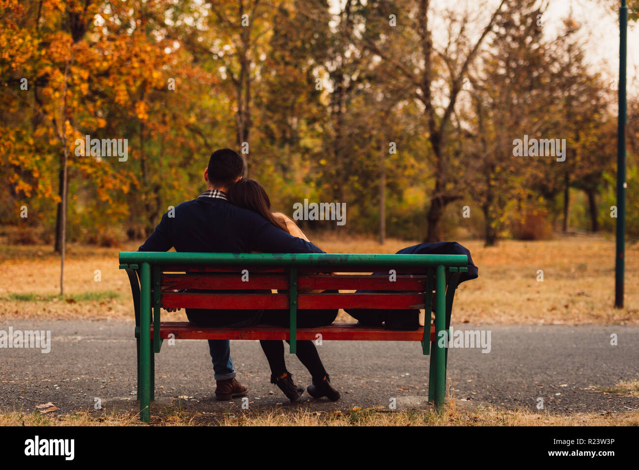 Boyfriend and girlfriend sitting on the bench together talking and ...
