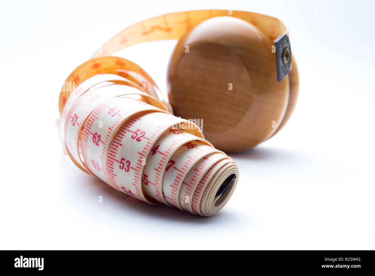 Yo-yo effect in diet concept. Wooden yoyo with centimeter measure ...