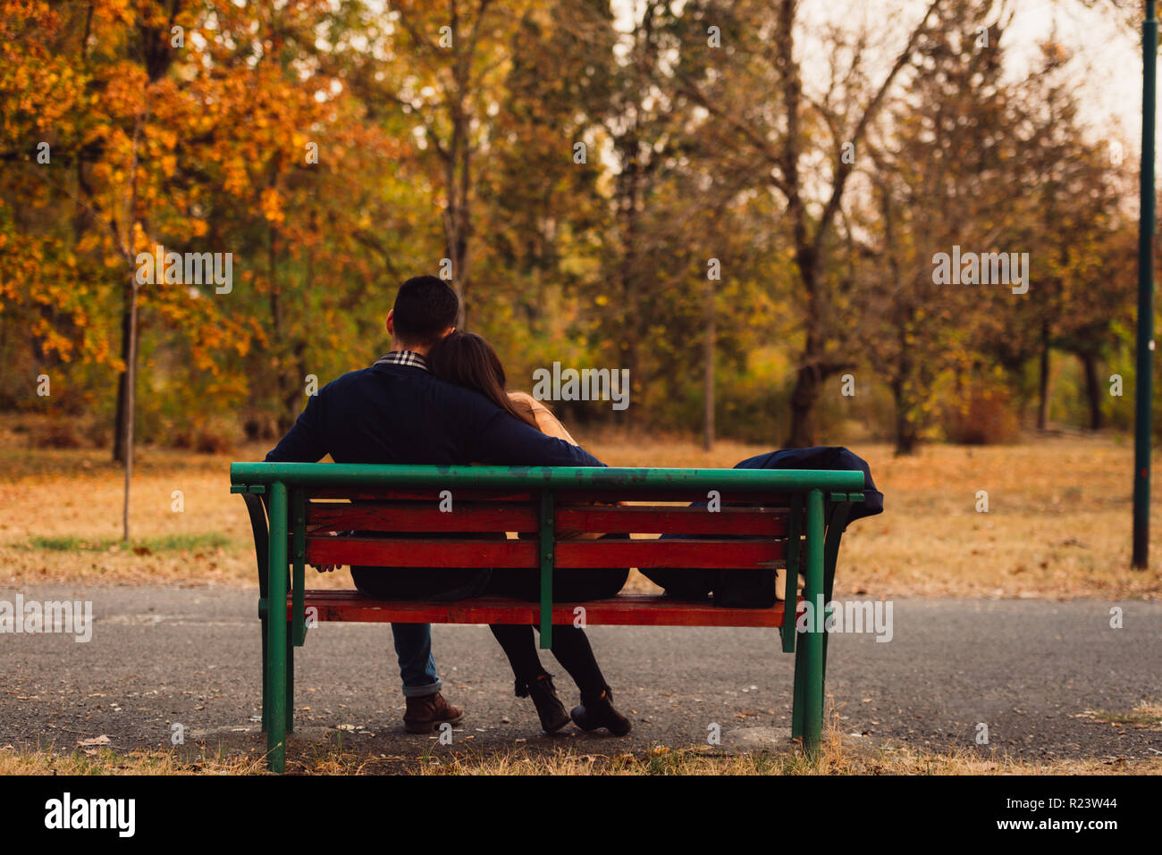 Couple On Bench Kissing In Stock Photos & Couple On Bench Kissing In ...