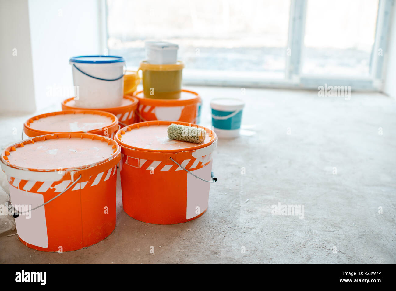Buckets with building mix on the floor at the construction site indoors ...