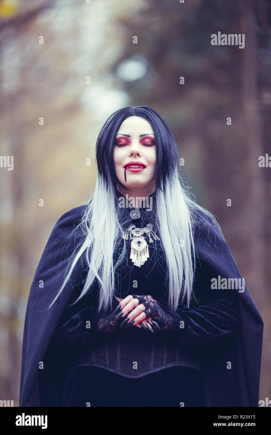 Image of vampire woman with eyes closed with blood at mouth Stock Photo ...