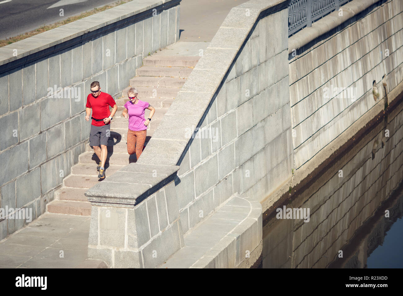 Couple running down steps hi-res stock photography and images - Alamy