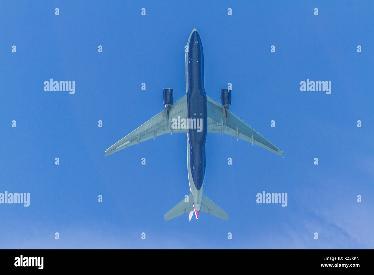 Airplane on blue sky, plane belly. Airplane view from under Stock Photo ...