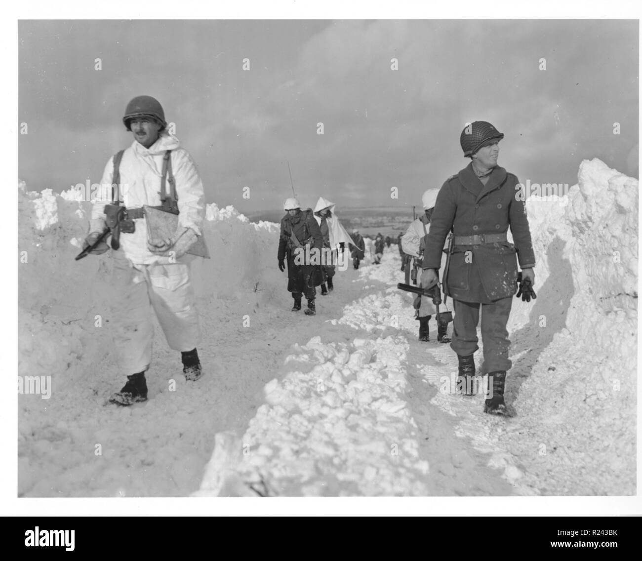 American infantrymen of an armoured division march up a road southeast ...
