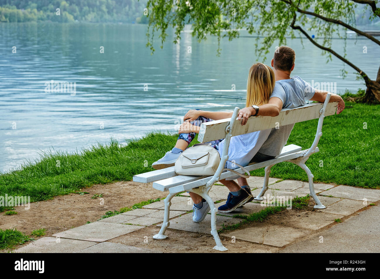 Couple sitting on lakeside bench hi-res stock photography and images ...