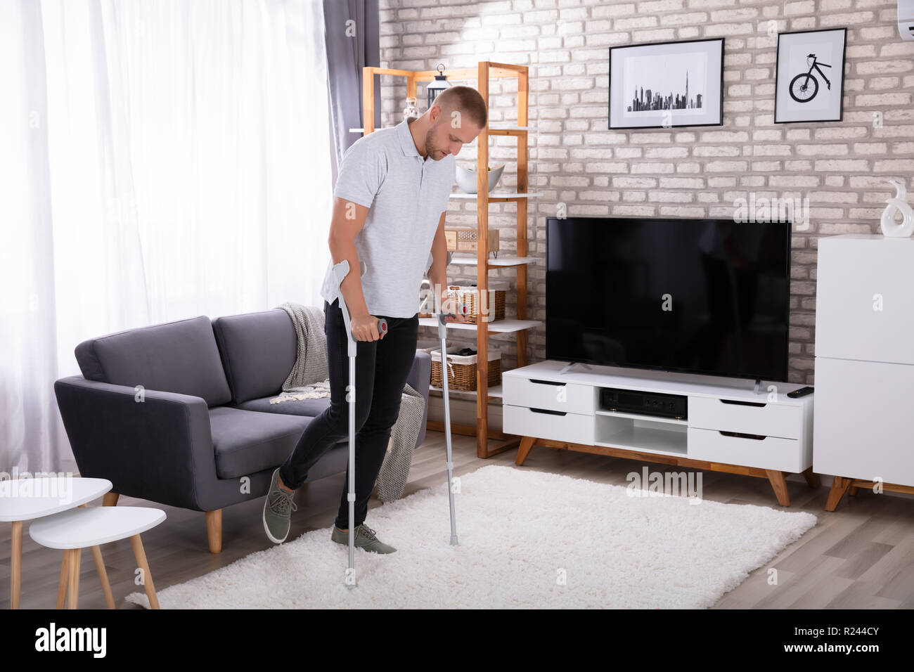 Person on crutches hi-res stock photography and images - Alamy