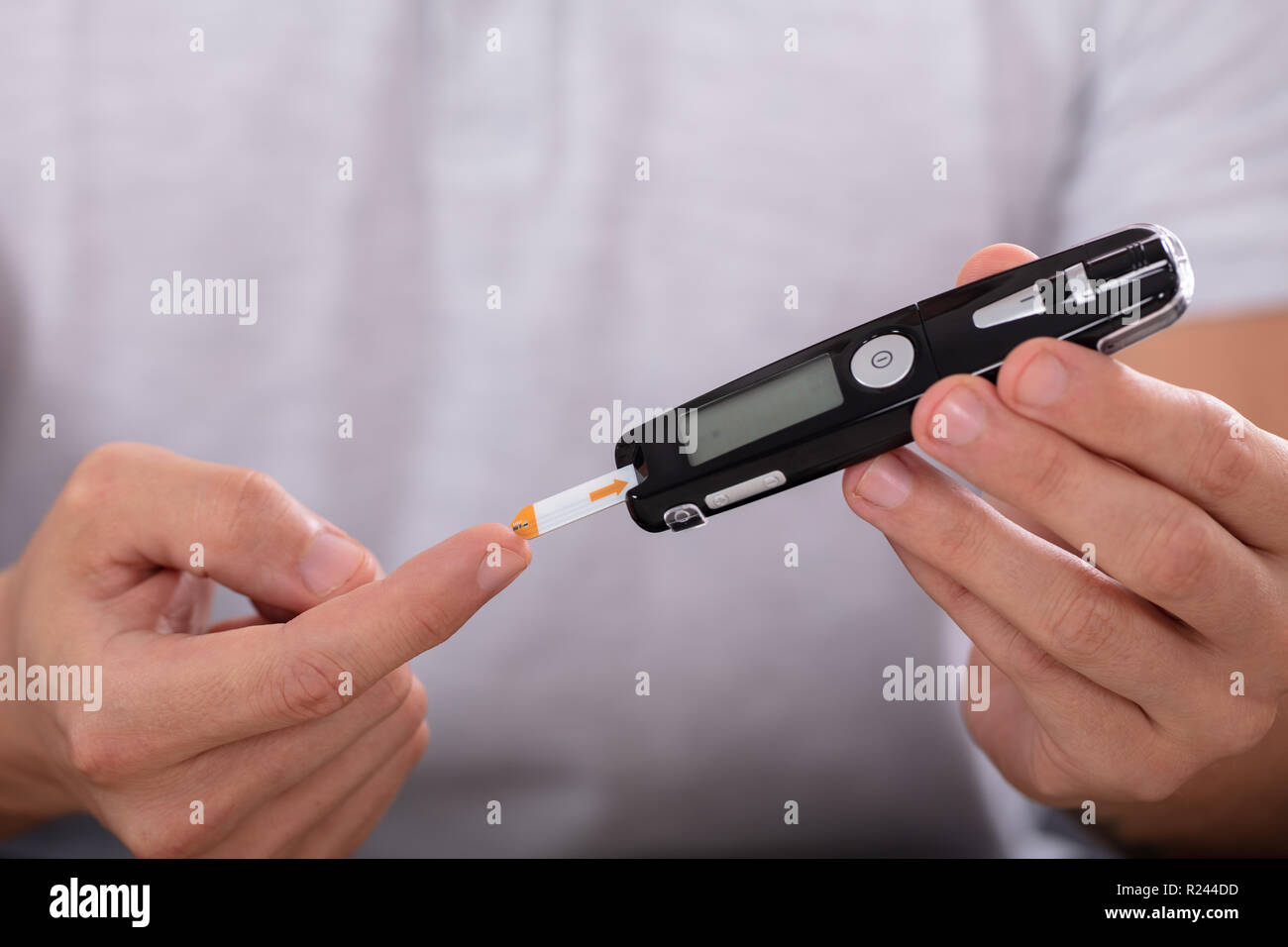 Close-up Of A Man's Hand Checking Blood Sugar Level With Glucometer ...