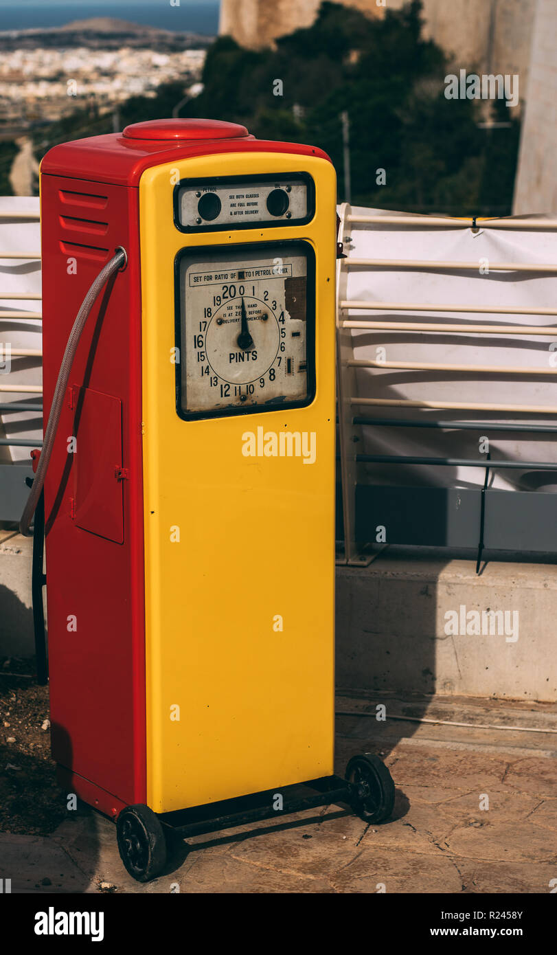 Red and yellow retro fuel filling column Stock Photo - Alamy