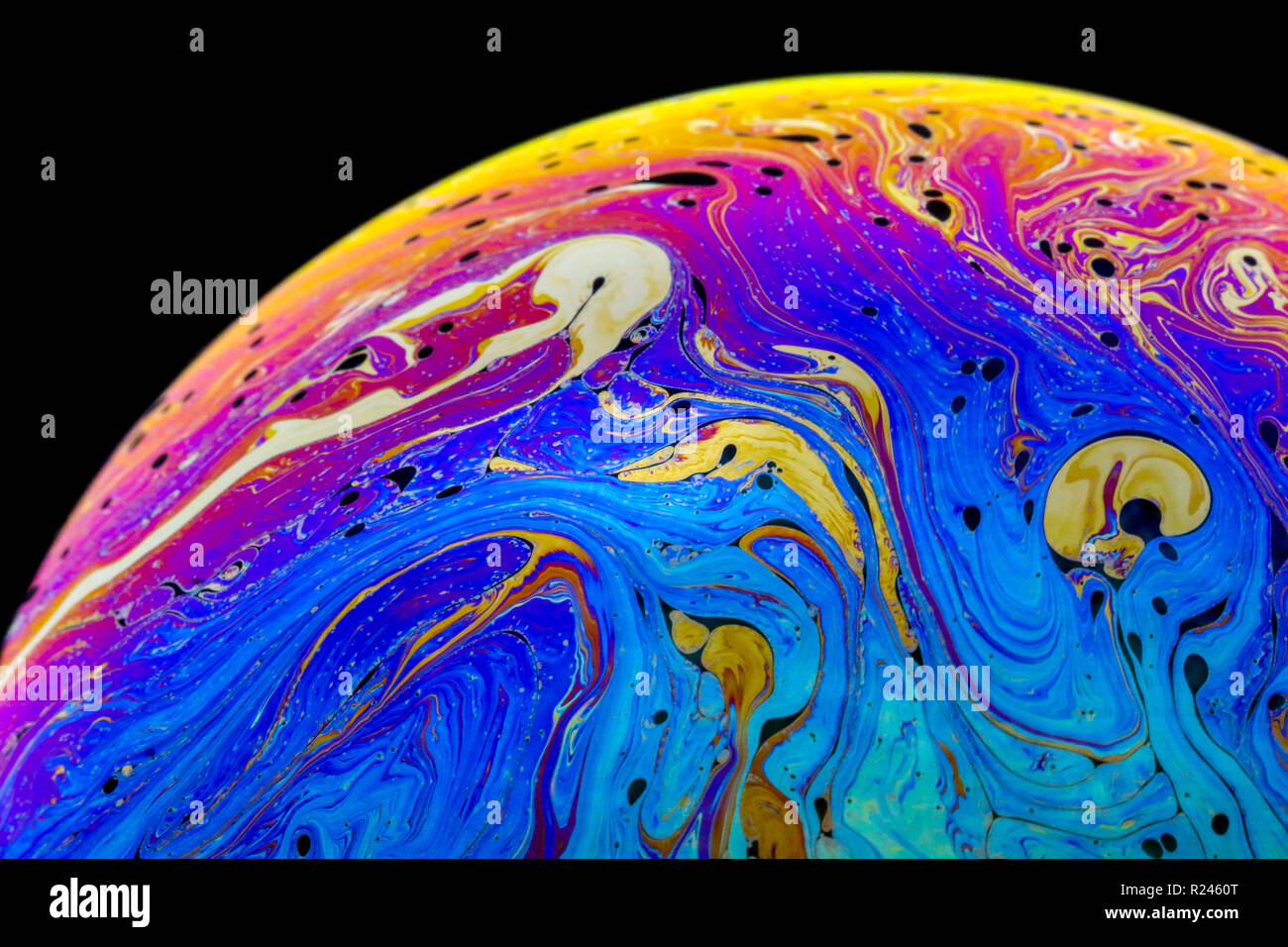Close up rainbow colours in a soap bubble that look like space or ...
