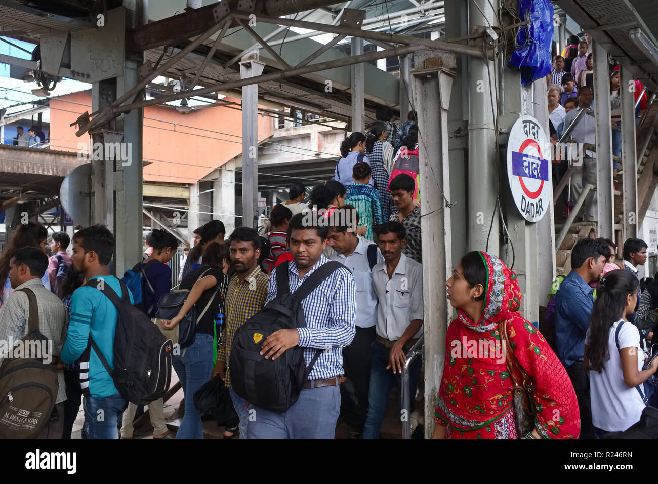 A pre-rush hour crowd of commuters on a platform at Dadar Station in ...