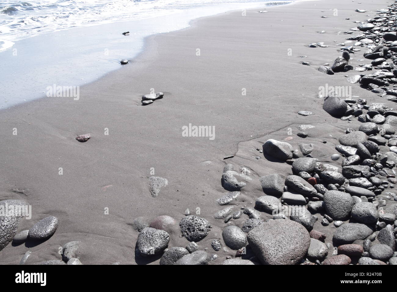 Sandy Beach with pebbles Stock Photo - Alamy