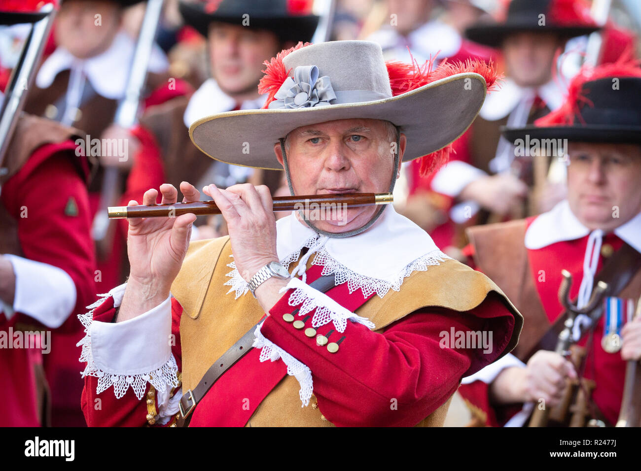 A piper in a military Marching band as it parades past the Grandstand ...