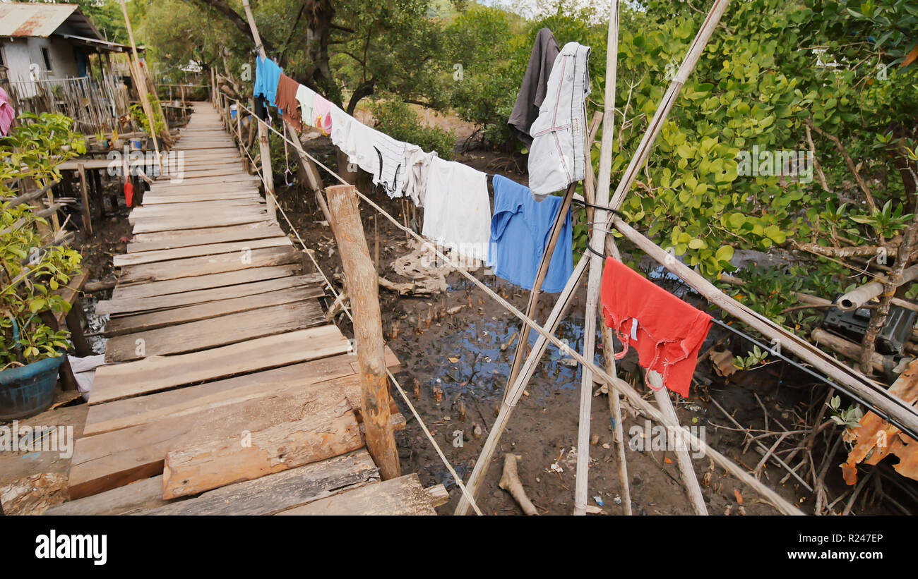Houses of the poor in the Filipino slums. The swamp. Wooden bridges ...