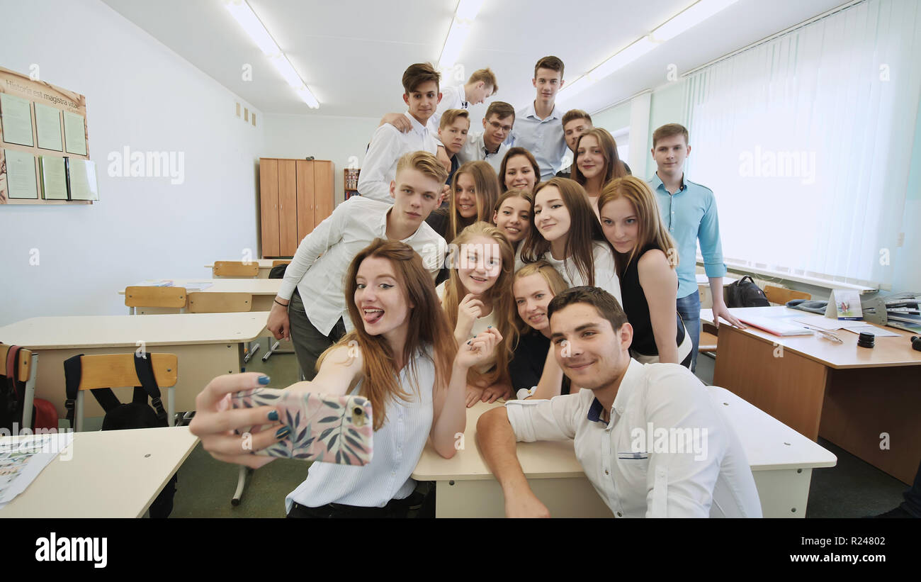 Young happy cheerful students making selfie in school class Stock Photo ...