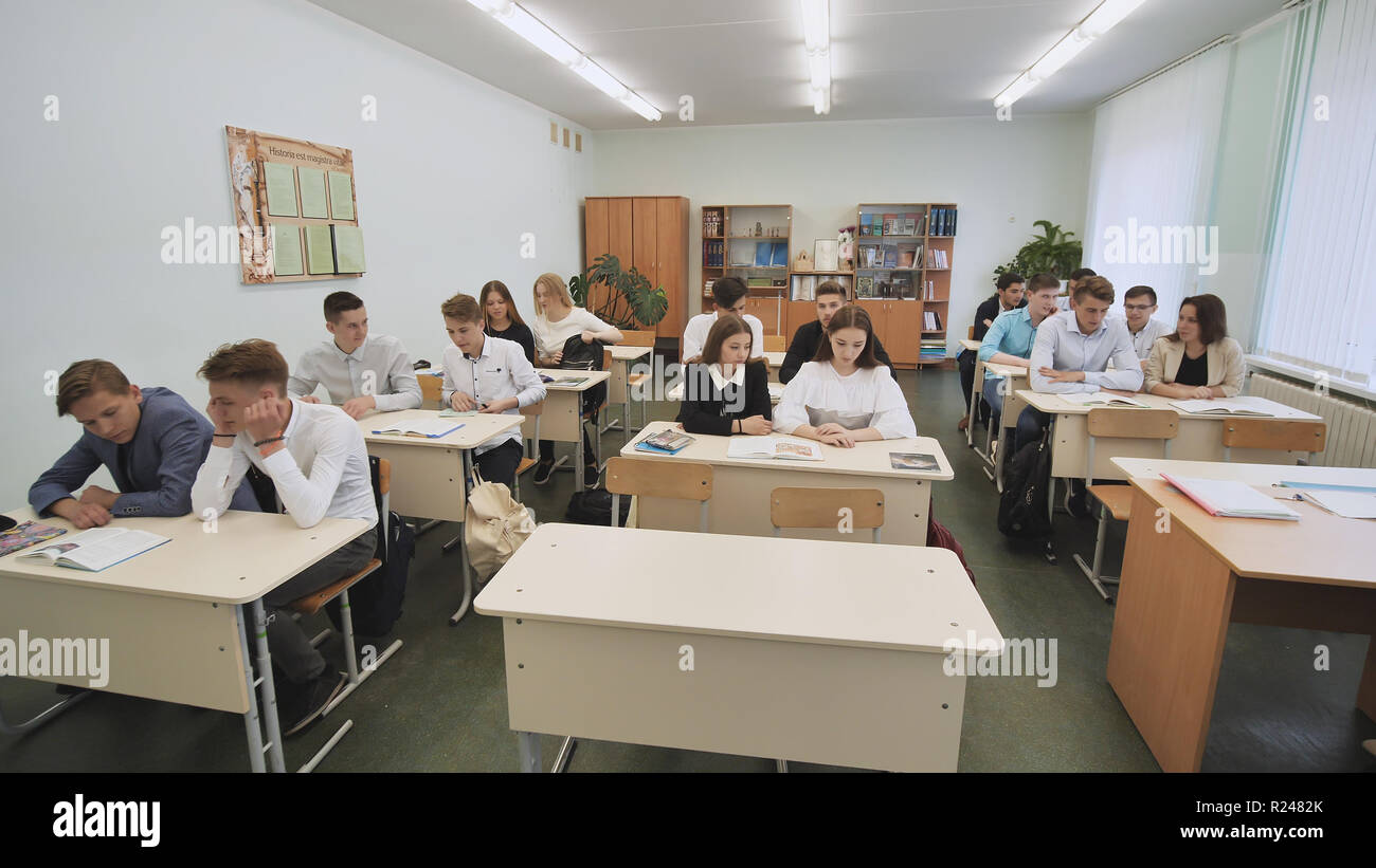Students in the classroom sit at school desks before the lesson ...