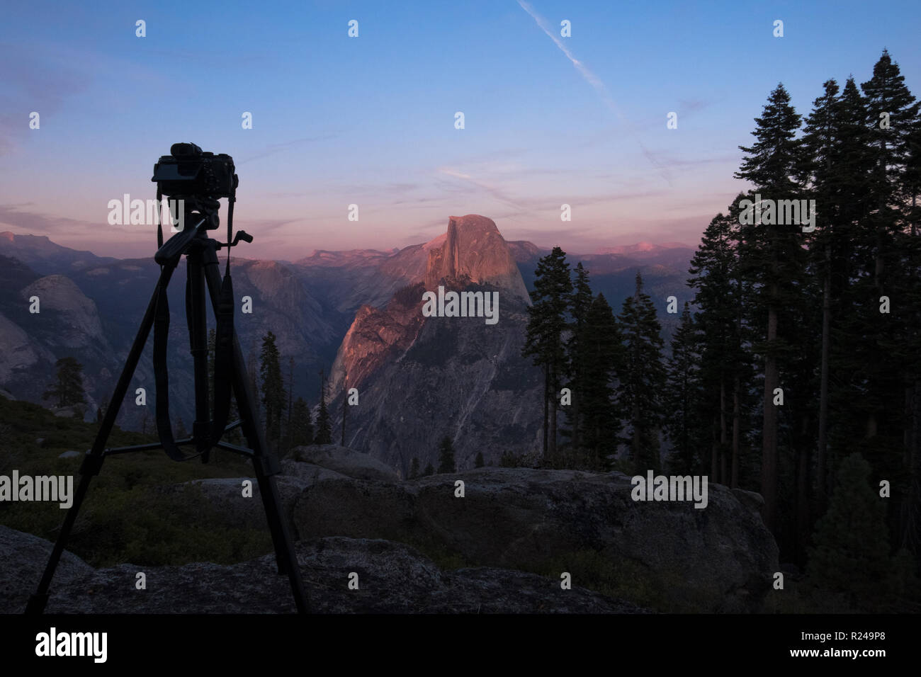 DSLR Camera on tripod taking photos of dramatic sunset light on ...