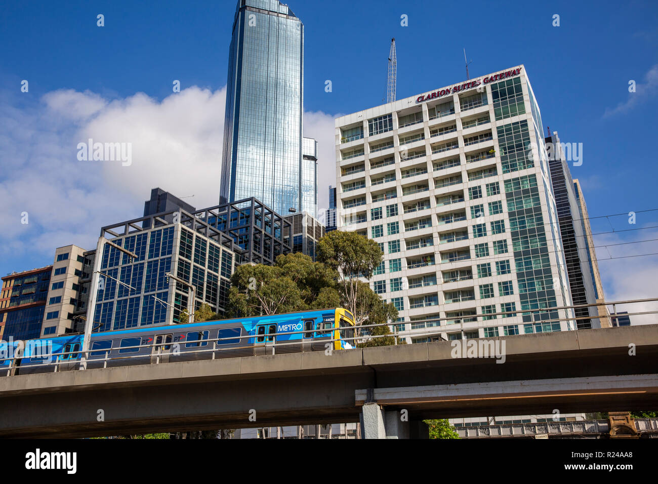 Melbourne metro train passes high rise office buildings in the city ...