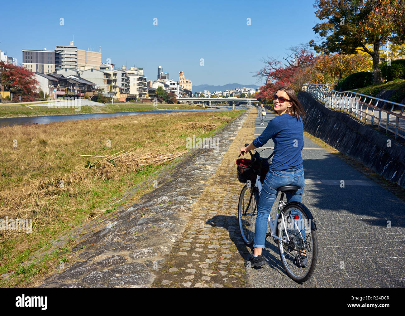 Cycling along the bank of the Kamo River in autumn, Kyoto, Japan, Asia ...