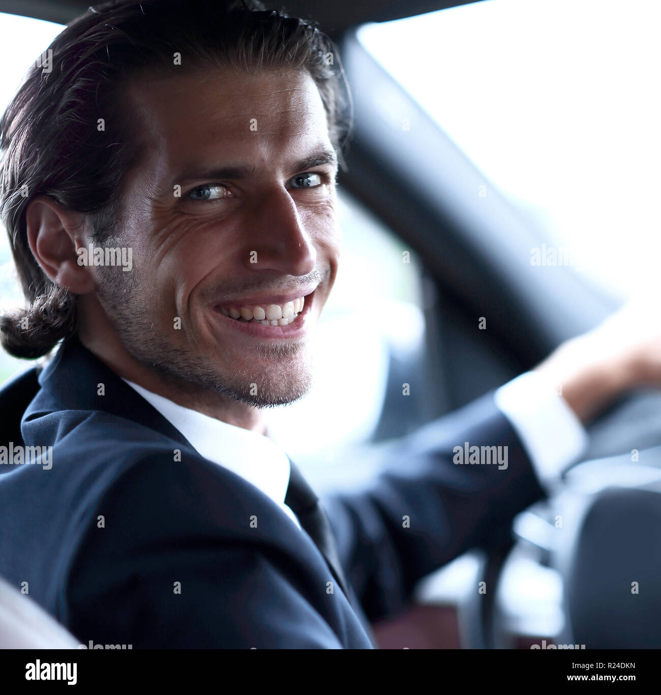 man sitting behind the wheel of a car Stock Photo - Alamy