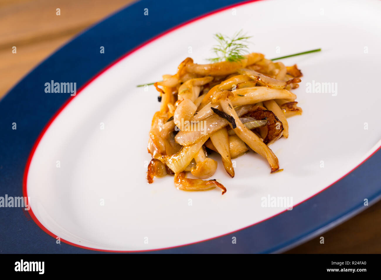 Plate of fried honey fungus mushrooms with onion, chives and dill Stock ...