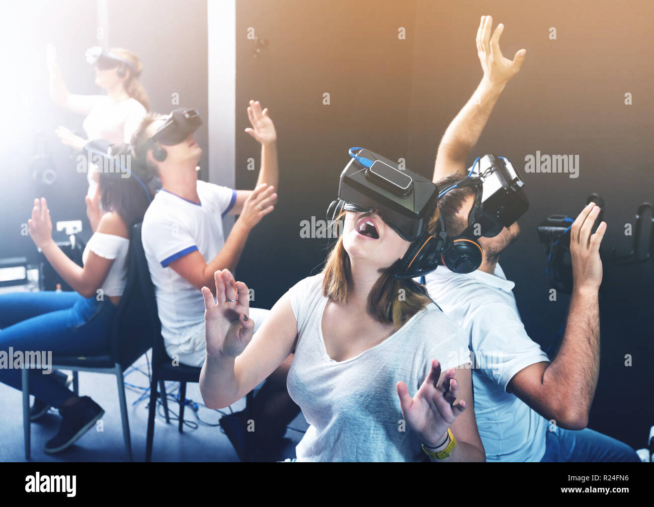 Young happy people having fun with new technology of vr headset goggles ...