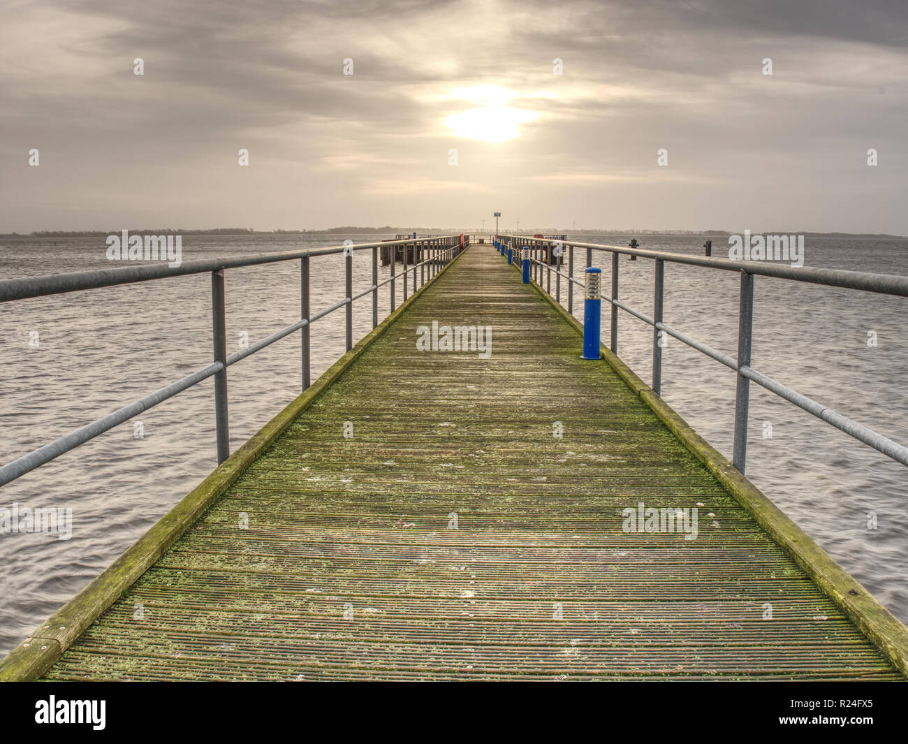 Sunrise over ocean. Empty wooden pier at moody colorful morning ...