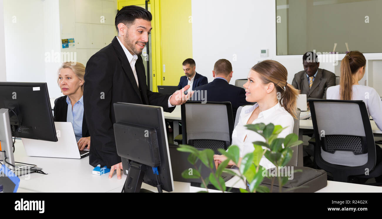 Friendly coworkers having pleasant fun conversation and flirting at ...