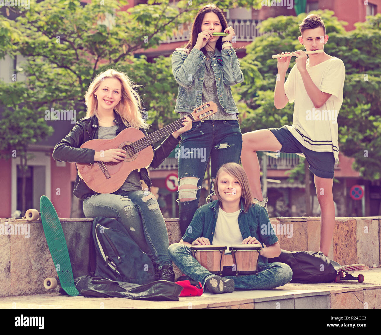 Teenagers friends with musical instruments together outdoors Stock ...