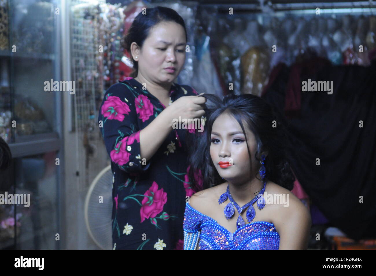 Beautiful Cambodian bride in a beauty parlor getting her hair done ...