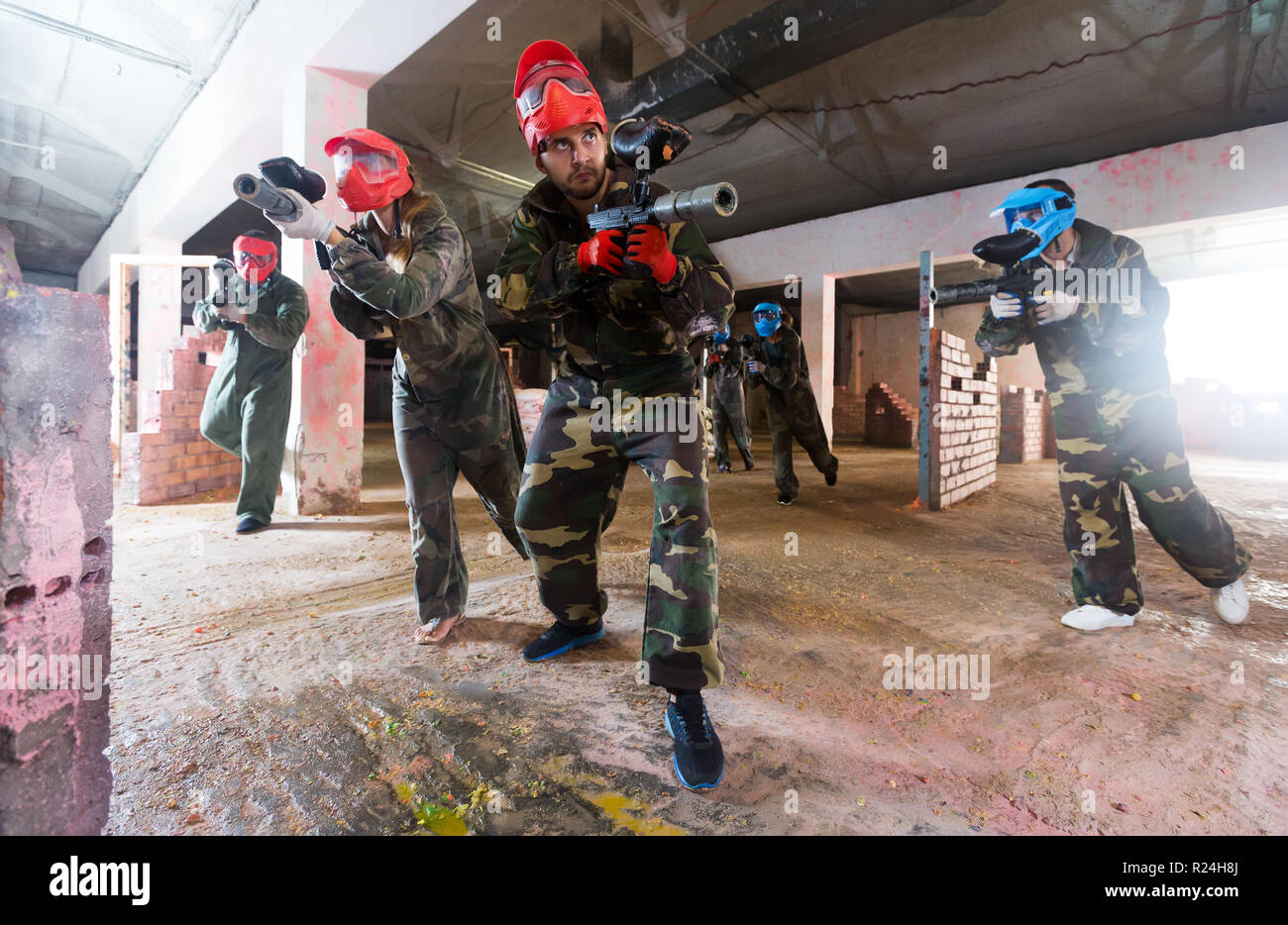 Red team of young people are ready for attack on battlefield in ...