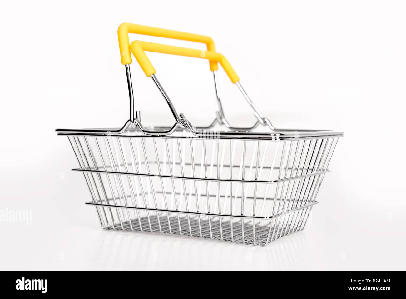 Yellow shopping basket isolated in a white background Stock Photo - Alamy