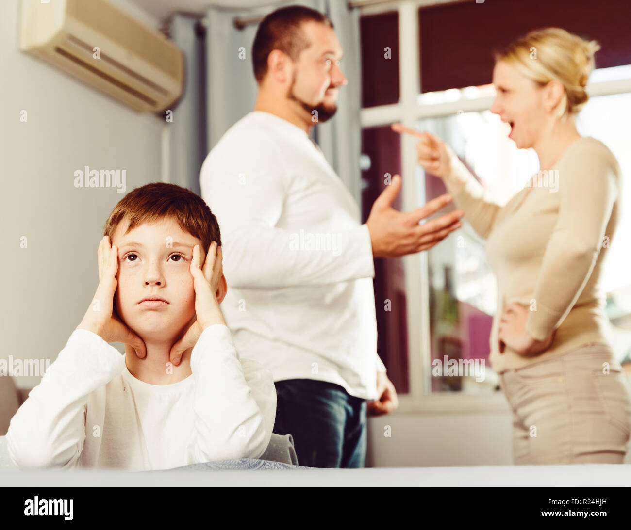 Sad desperate little boy during parents quarrel in home interior Stock Photo - Alamy