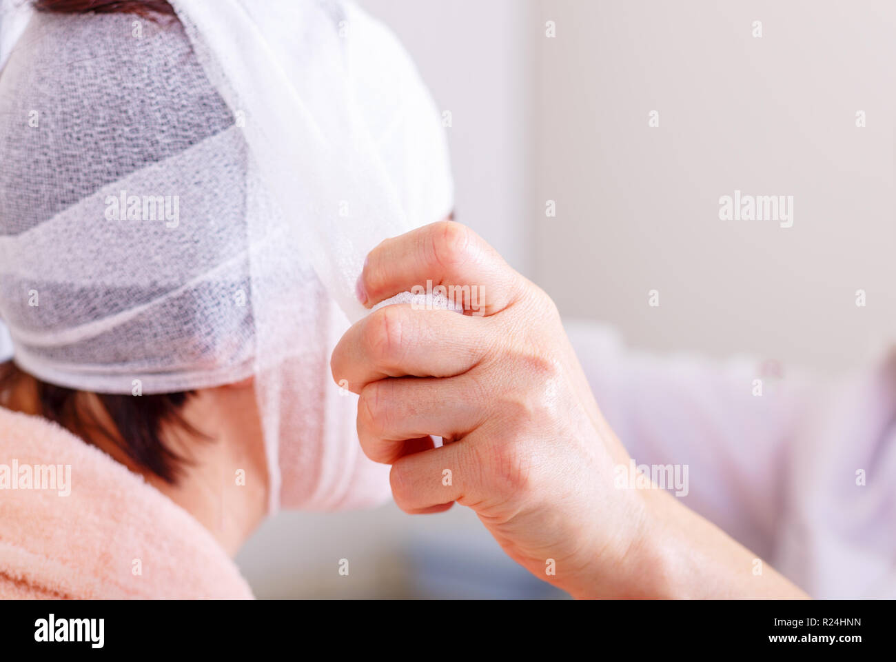 Doctor makes a bandage on head patient at clinic Stock Photo - Alamy