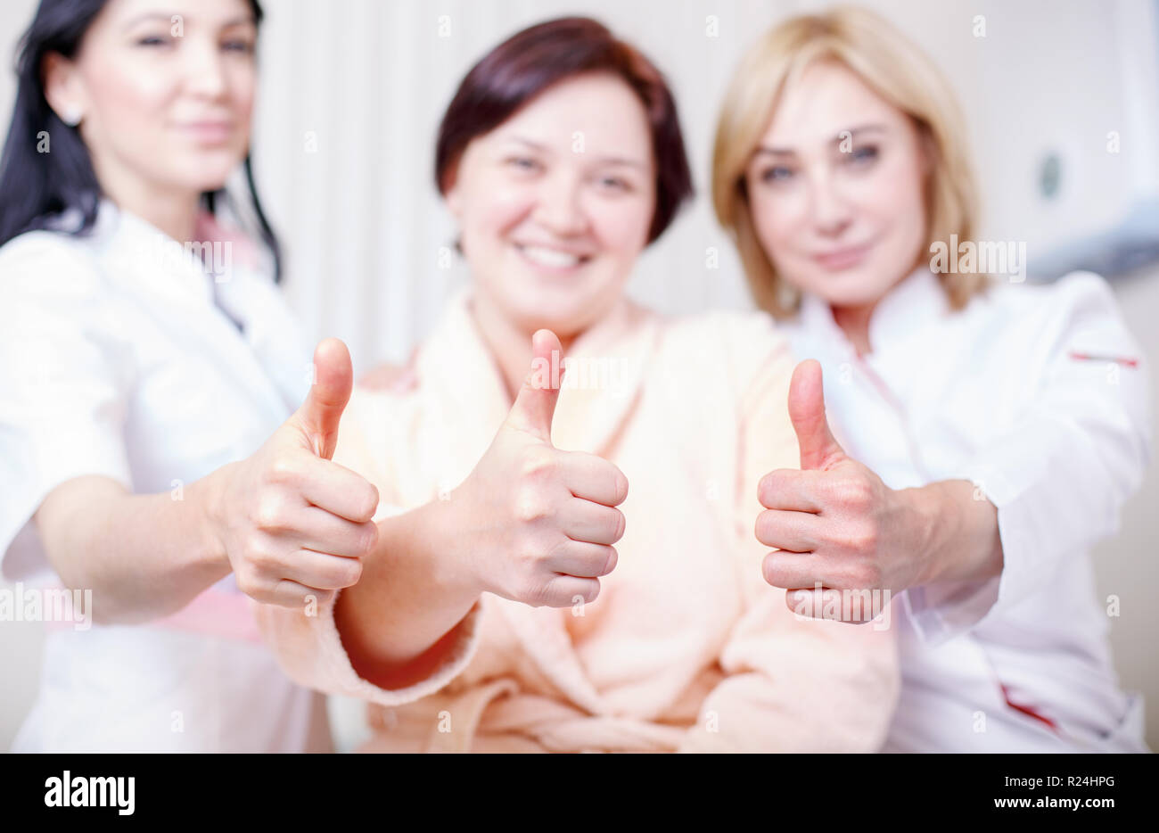 Doctors with a happy patient show like Stock Photo - Alamy
