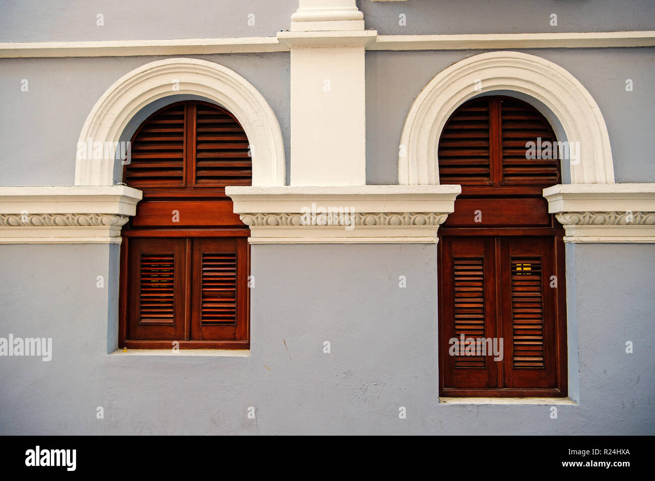 windowBig and small with wooden shutters on grey wall background in San ...
