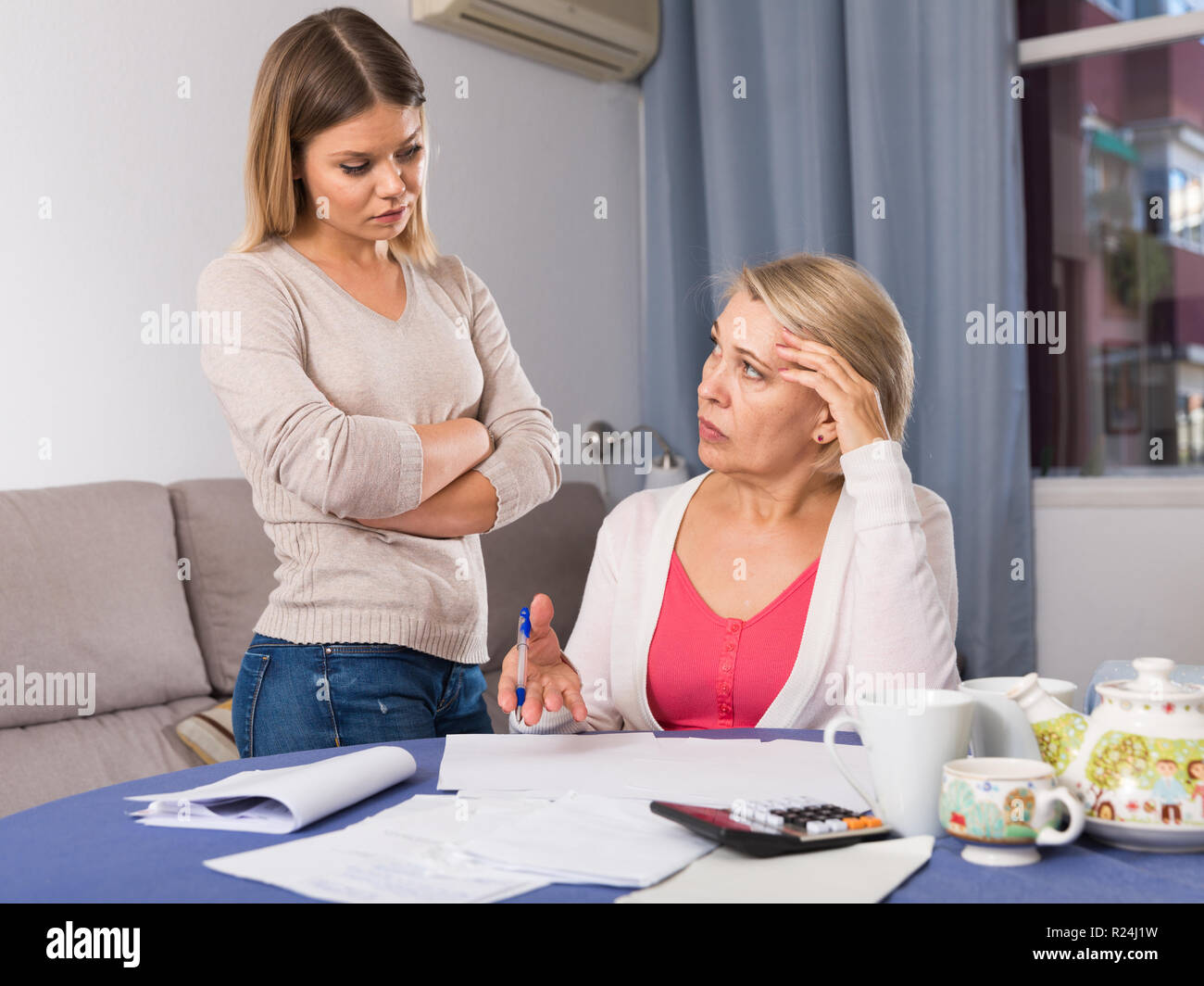 Grown daughter helps her mother deal with bills and taxes Stock Photo ...