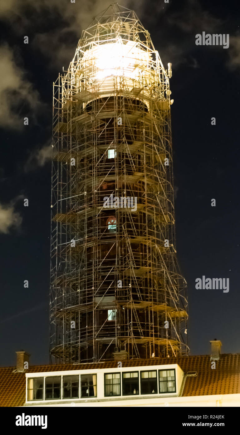 lighthouse in scaffolding for construction with the light shining at ...